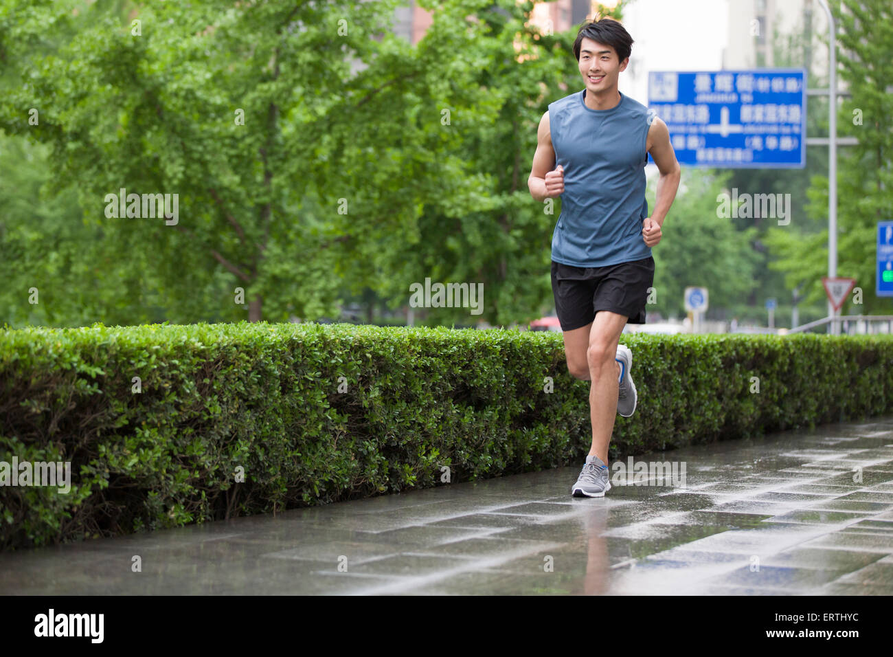 Young man running outside Stock Photo - Alamy