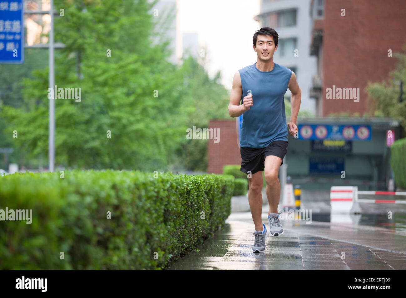 Young man running outside Stock Photo - Alamy