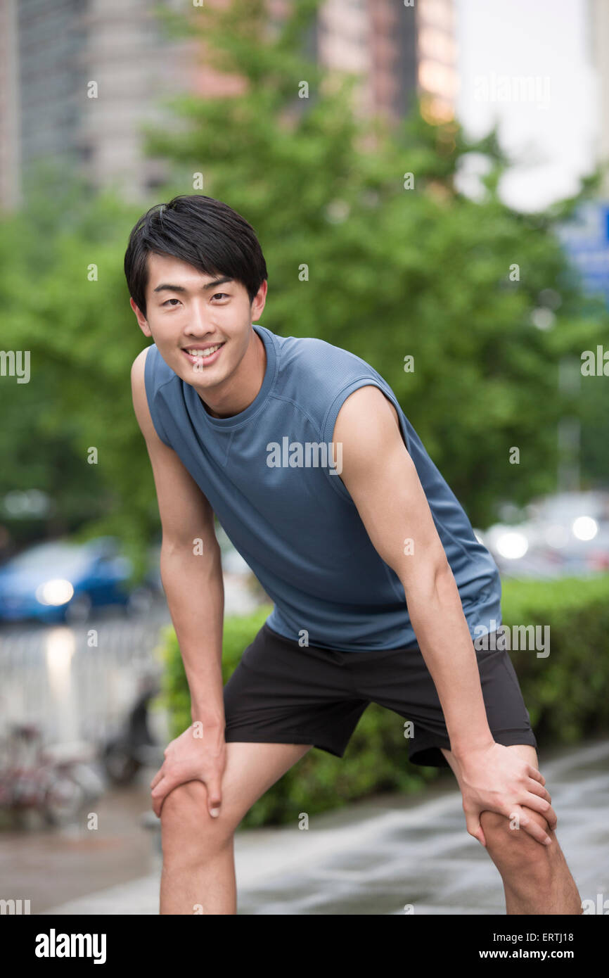 Young man taking a break from exercise Stock Photo - Alamy