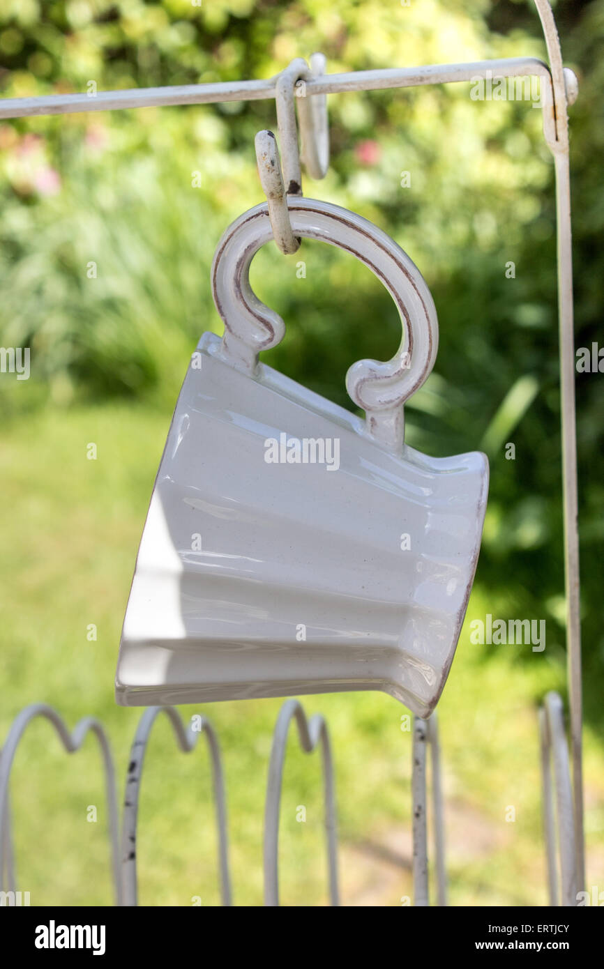 white cup hanging on a rack Stock Photo - Alamy