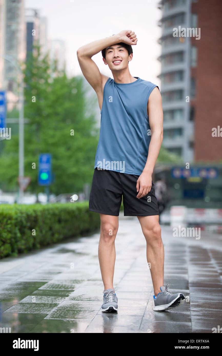Young man taking a break from exercise Stock Photo - Alamy
