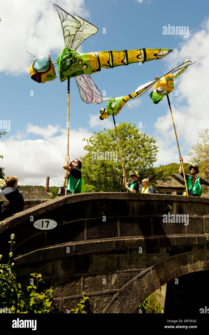 Dragon fly puppets being carried over the canal in The Handmade Parade ...