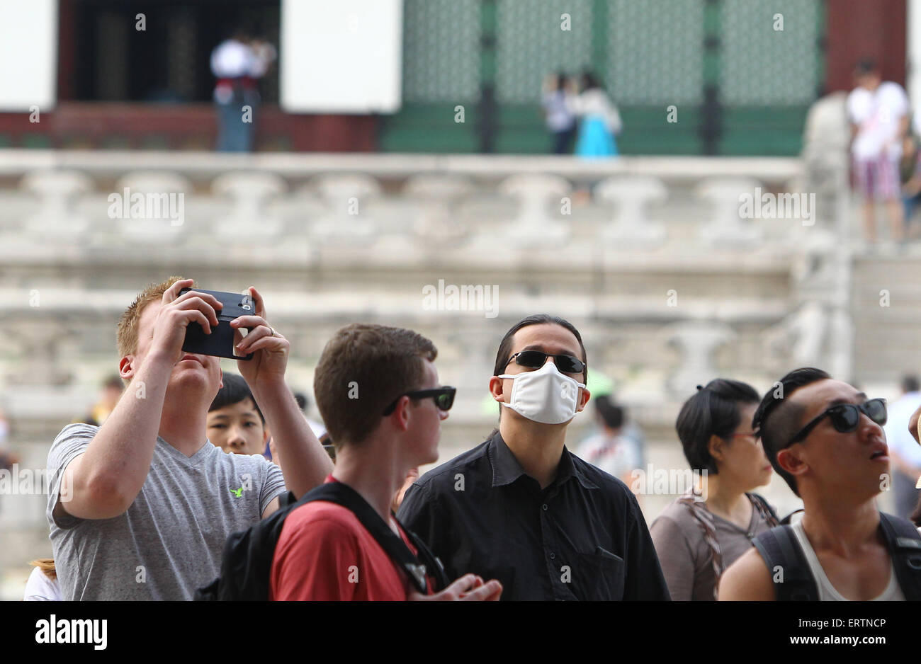 Seoul, South Korea. 8th June, 2015. Tourists walk with masks at the ...