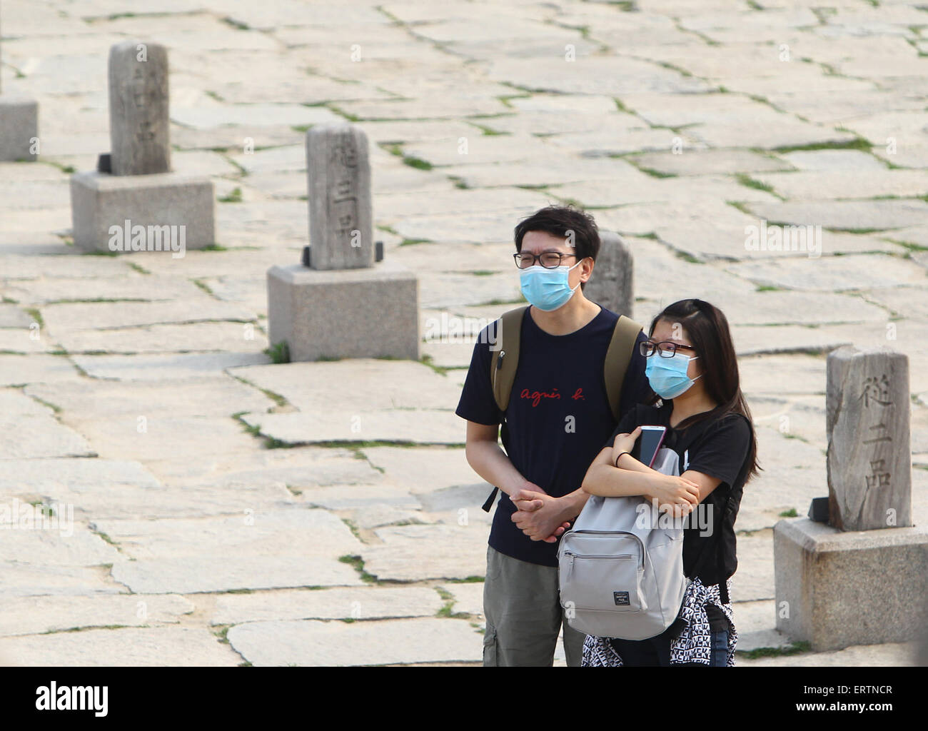 Seoul, South Korea. 8th June, 2015. Tourists walk with masks at the ...