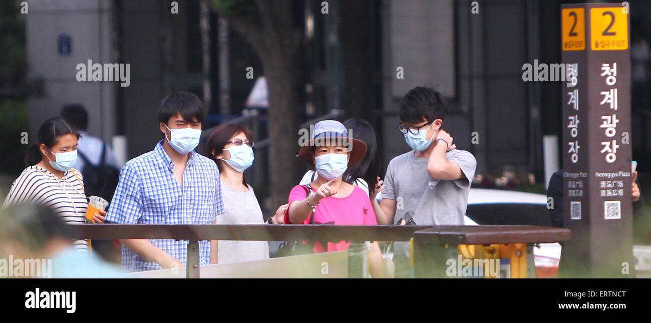 Seoul, South Korea. 8th June, 2015. Tourists walk with masks in Seoul ...