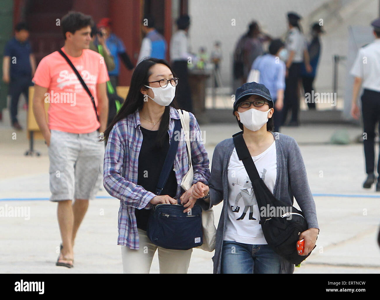 Seoul, South Korea. 8th June, 2015. Tourists walk with masks in Seoul ...