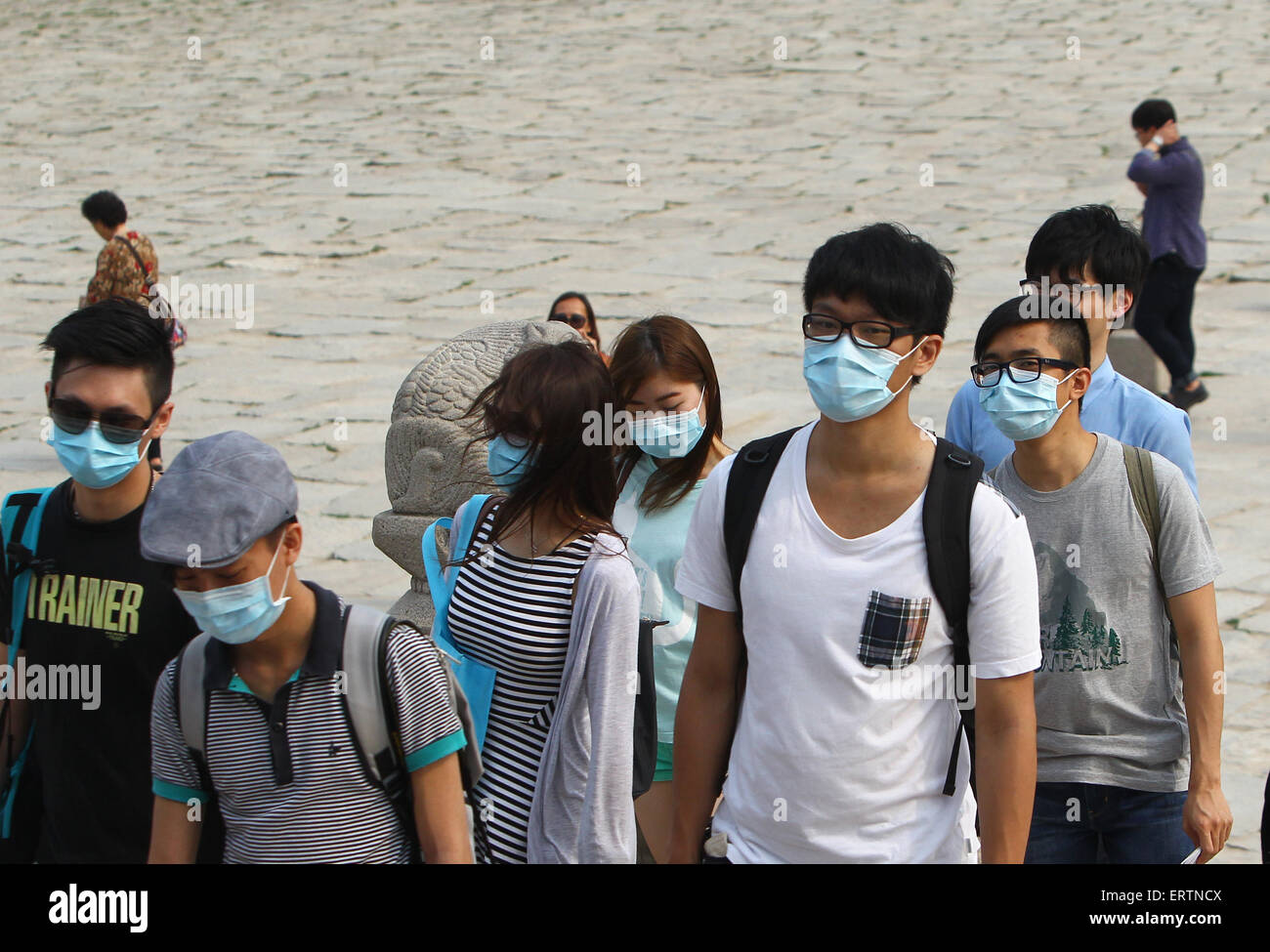 Seoul, South Korea. 8th June, 2015. Tourists walk with masks at the ...