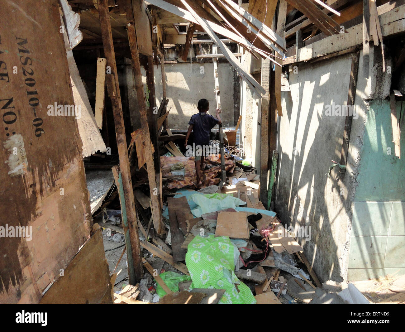 Navotas City, Philippines. 08th June, 2015. A child observes his home ...