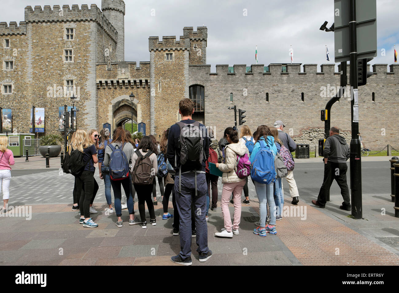 A tour group of foreign students waiting at traffic lights on their way ...