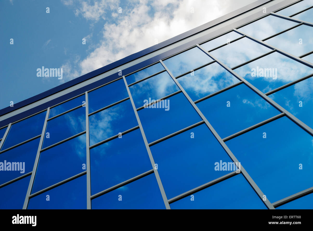 The facade of a modern building from blue glass reflects the sky Stock ...