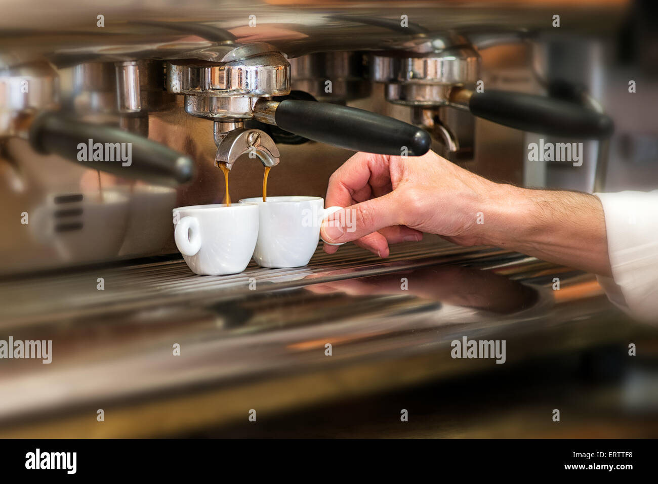 Close up view of the hand of a man working in a coffee house preparing ...