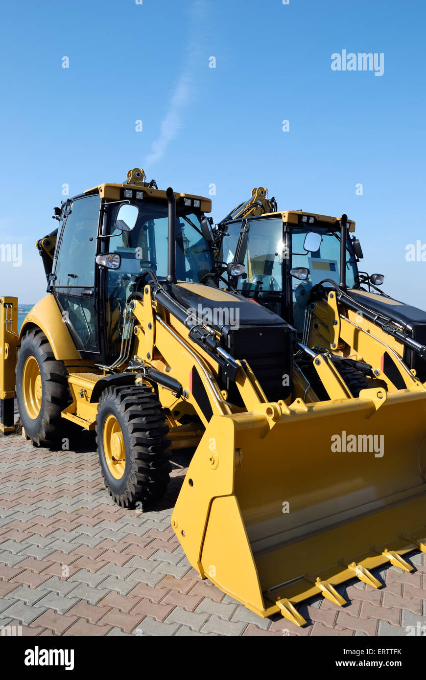 Two new bulldozers on a show-window Stock Photo - Alamy