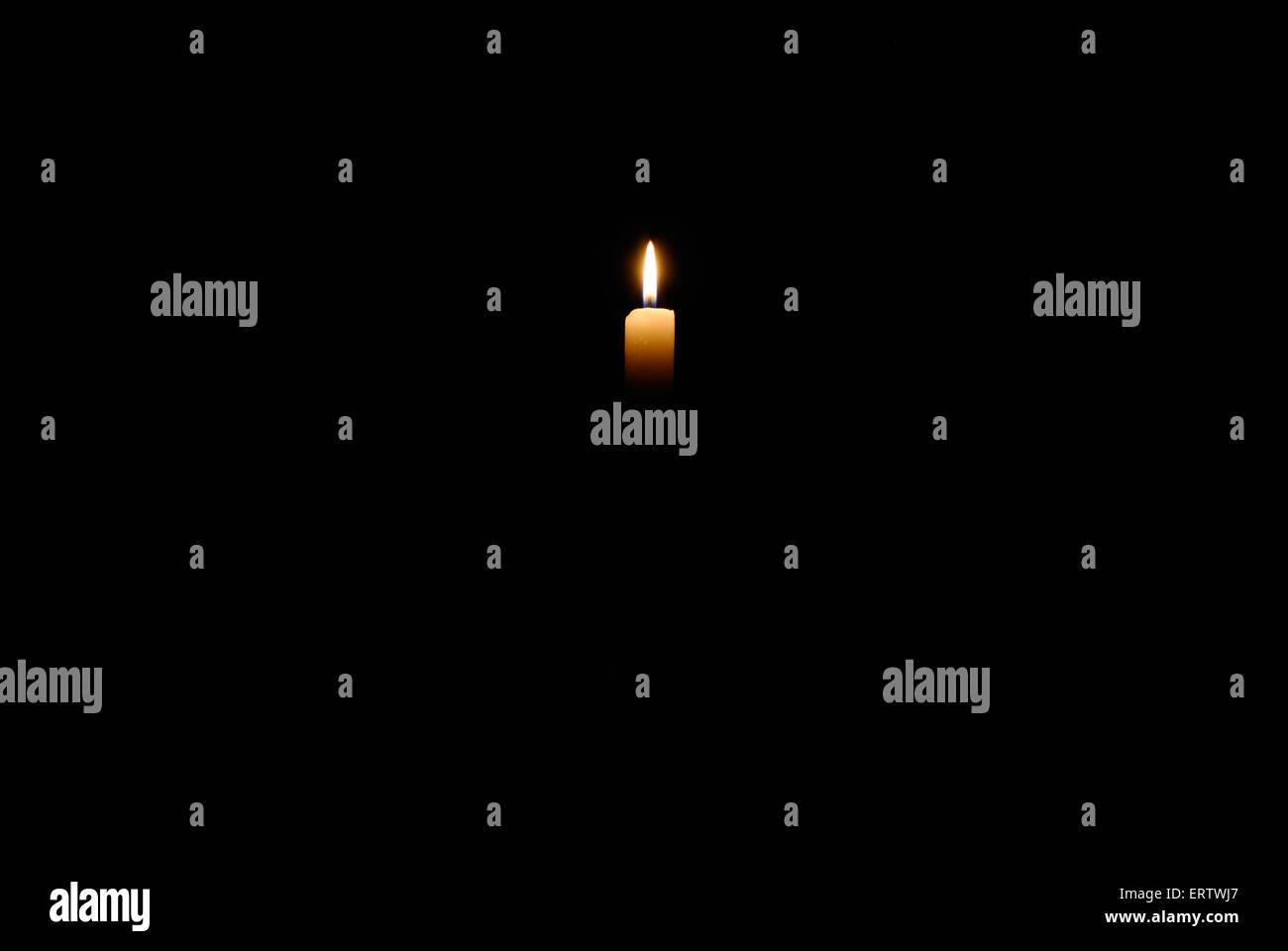 The burning candle disappears in the distance on black Stock Photo - Alamy