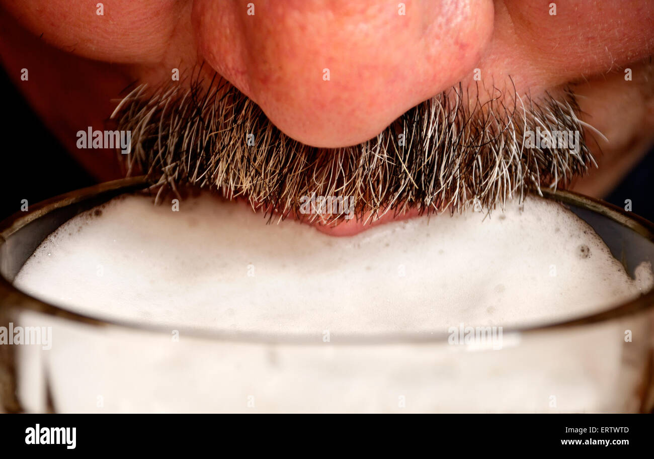 Closeup of the face drinking beer Stock Photo - Alamy