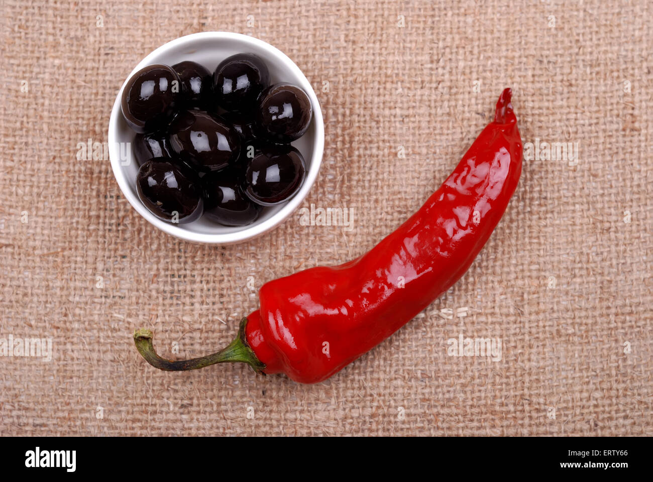 Red hot chili pepper and olives on a rough sackcloth Stock Photo - Alamy