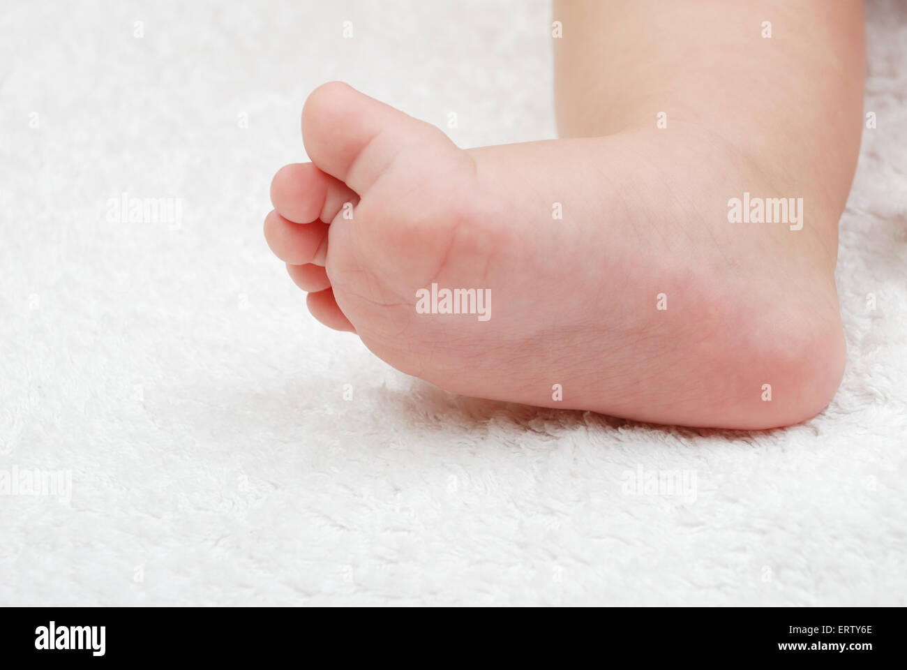 Children's foot on a soft light towel Stock Photo - Alamy