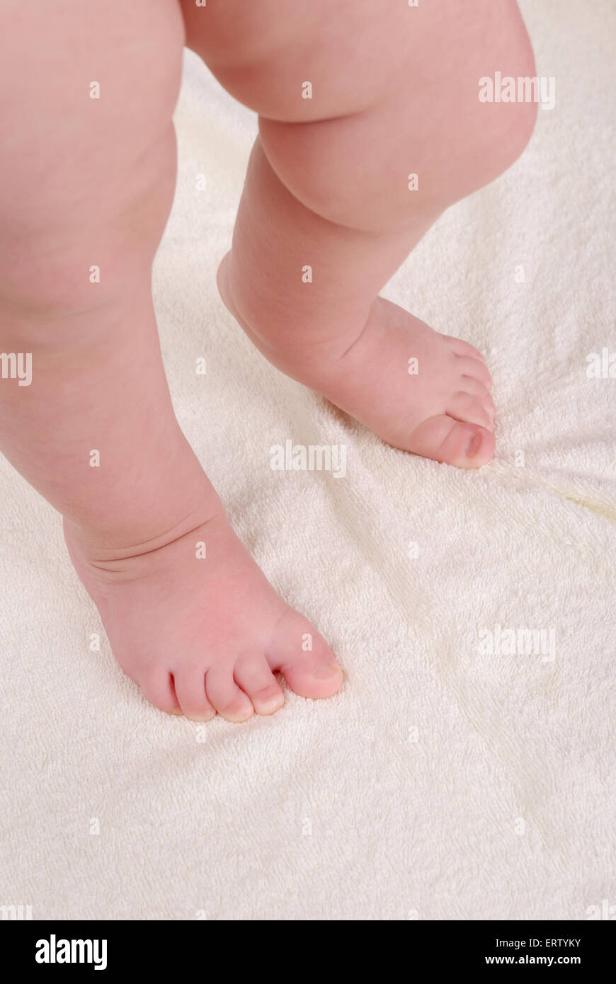 Children's legs on a soft light towel Stock Photo - Alamy