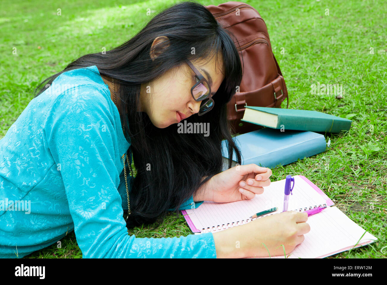College student writing home work outdoor in university Stock Photo - Alamy