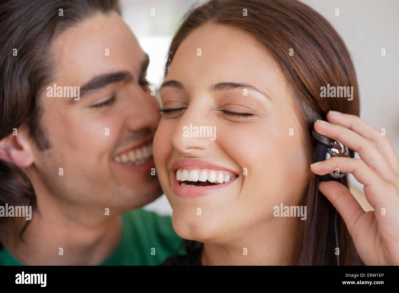 Man whispering woman's ear hi-res stock photography and images - Alamy