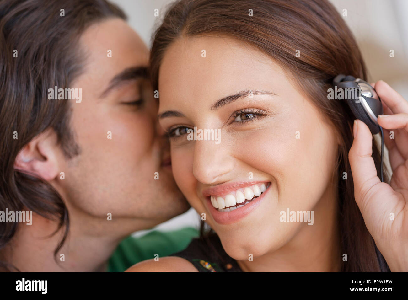 Man whispering woman's ear hi-res stock photography and images - Alamy