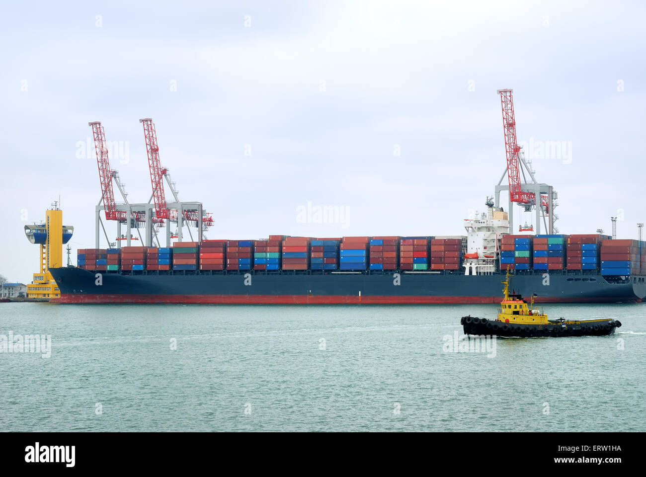 View on trading port with an unloading vessel Stock Photo - Alamy
