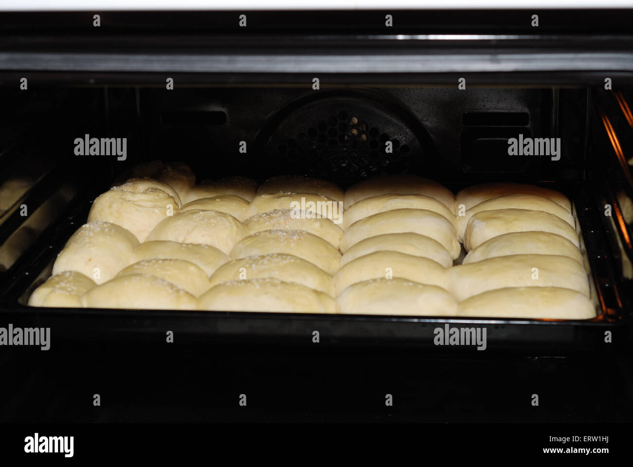 Rolls from the dough on a dripping pan before bake Stock Photo - Alamy