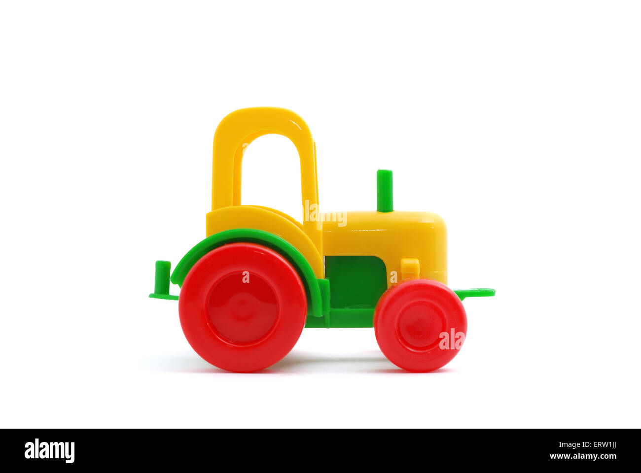 Small toy tractor a side view on white Stock Photo - Alamy
