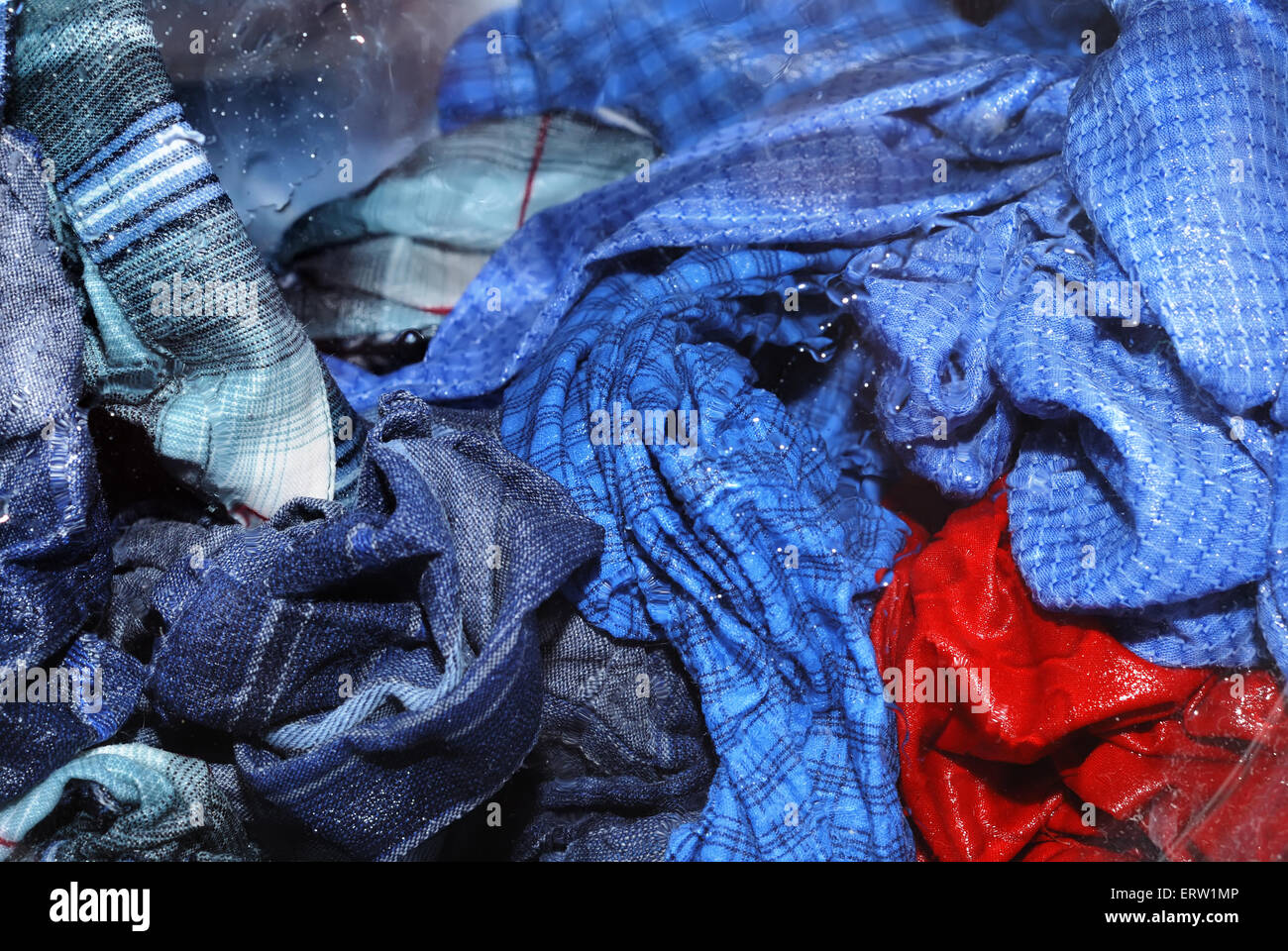The washing machine processing a colorful clothes Stock Photo - Alamy