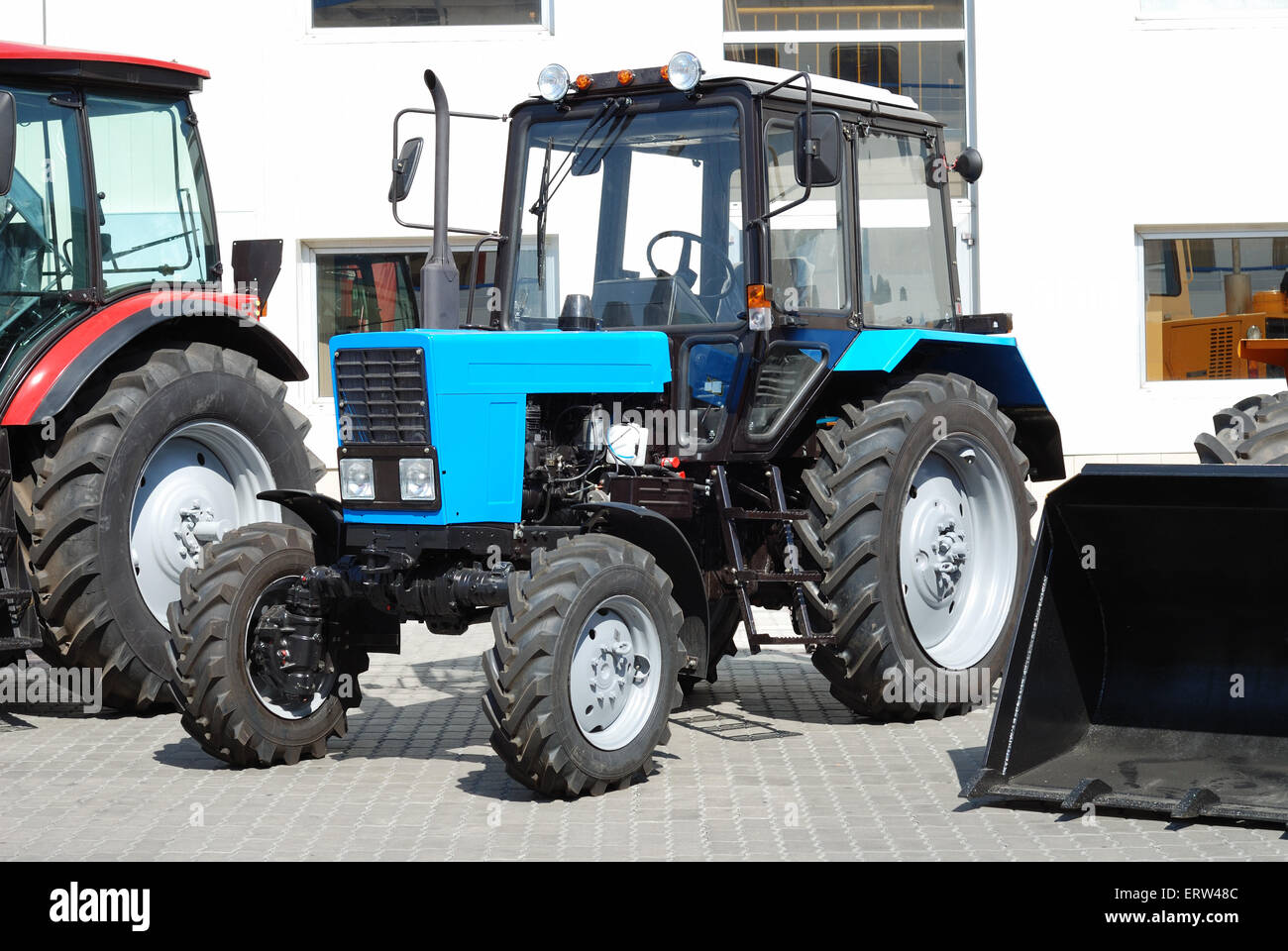 New blue tractor on a show-window Stock Photo - Alamy