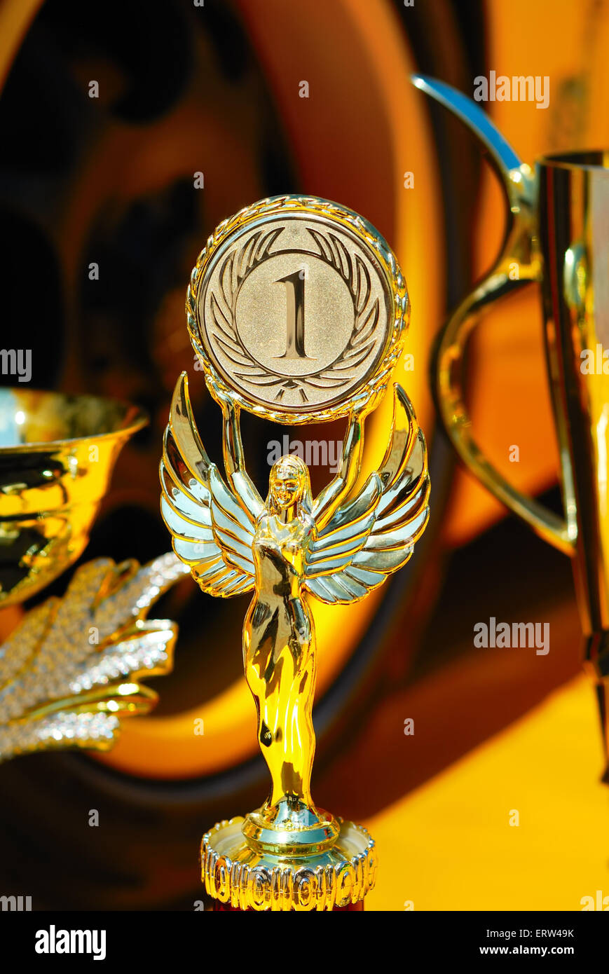 Trophies for winner and yellow wheel of racing car background Stock ...