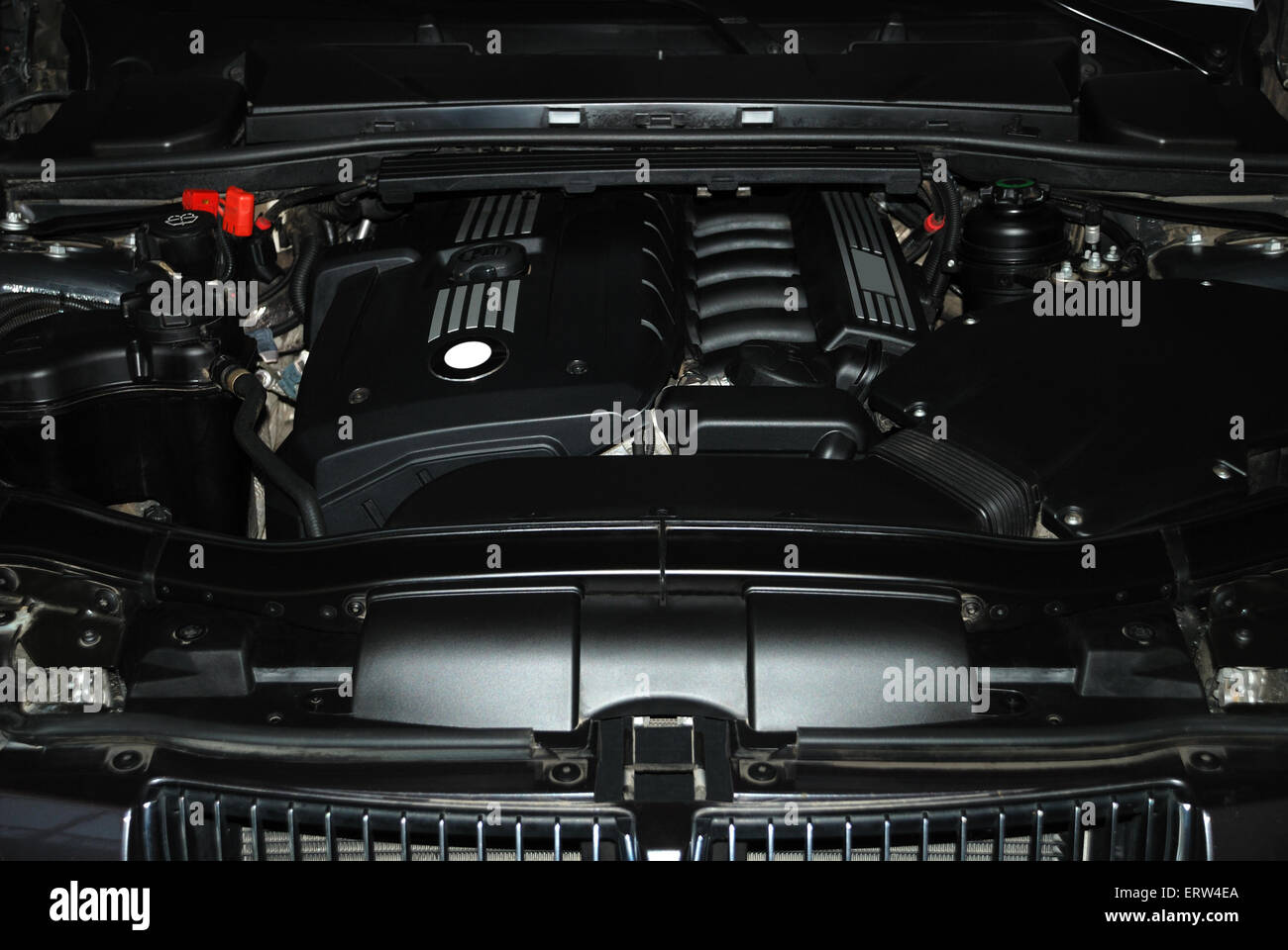 Black engine under the hood of a car Stock Photo - Alamy