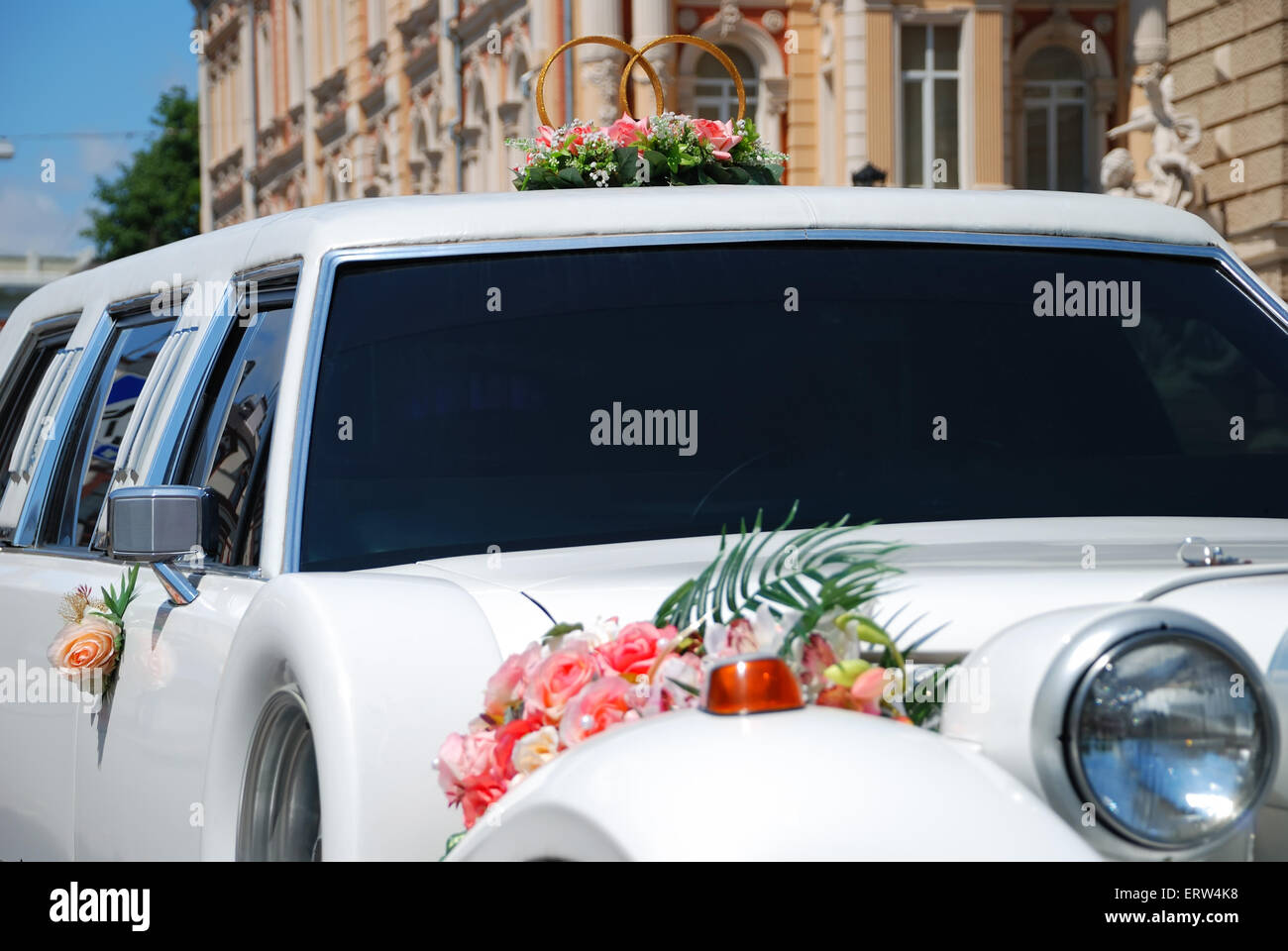 White wedding limousine decorated with flowers and rings Stock Photo ...