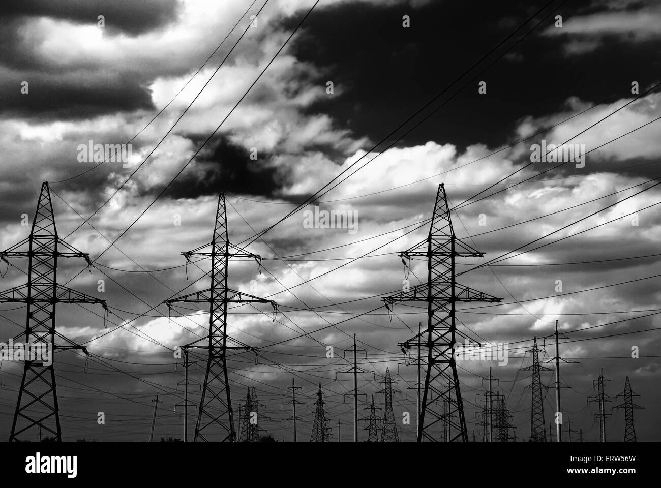Dark stylized high voltage electric line at the field Stock Photo - Alamy