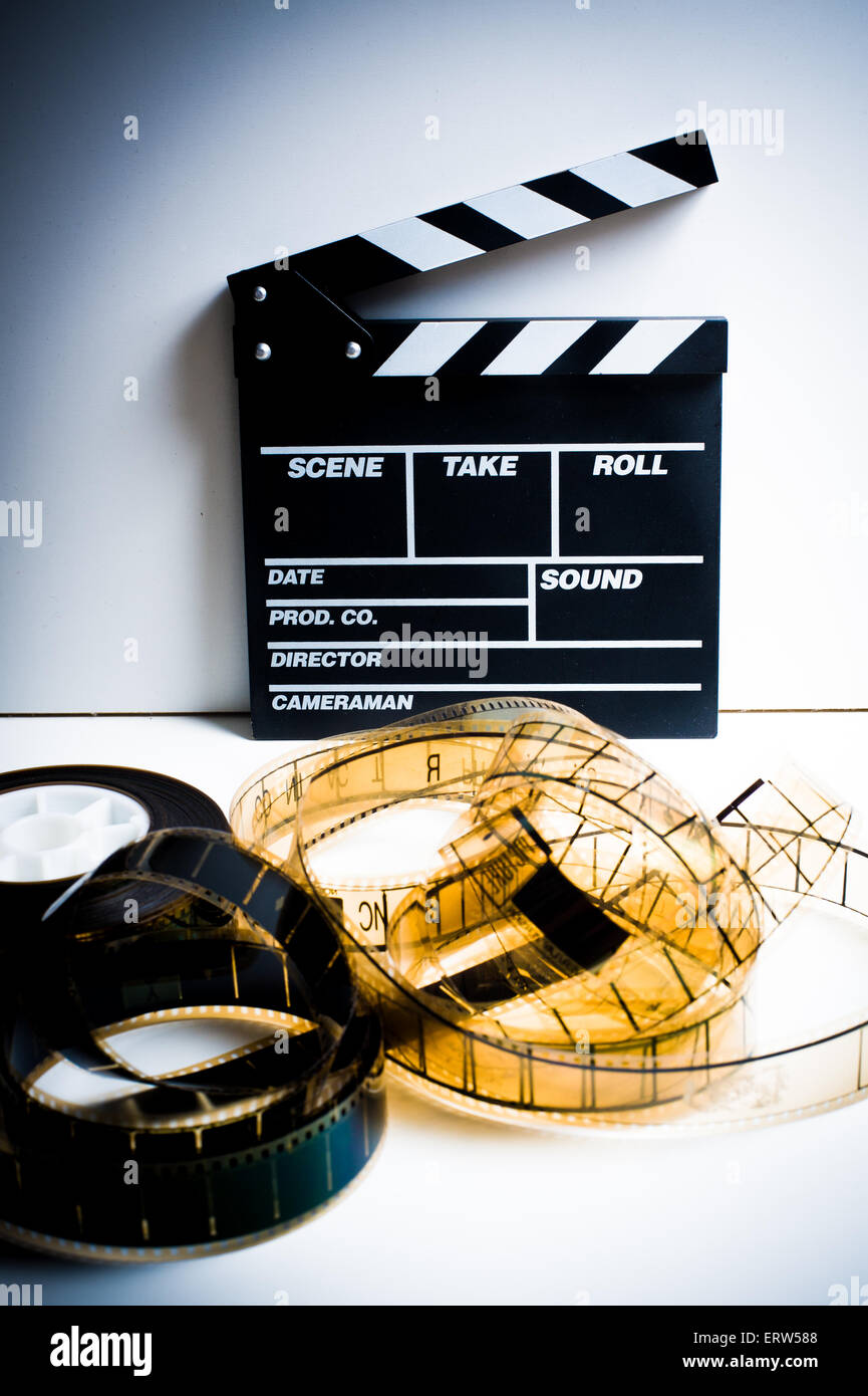 Movie clapper with 35 mm film on white background vertical frame ...