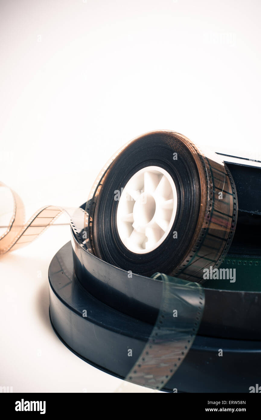 Vintage 35 mm movie reel and boxes on white background vertical frame ...