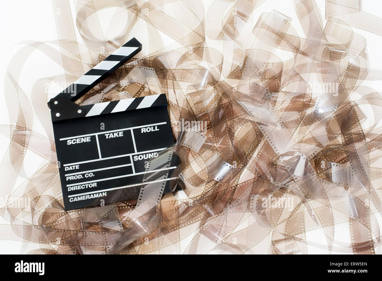 Clapper on 35mm movie unrolled filmstrip texture white background ...