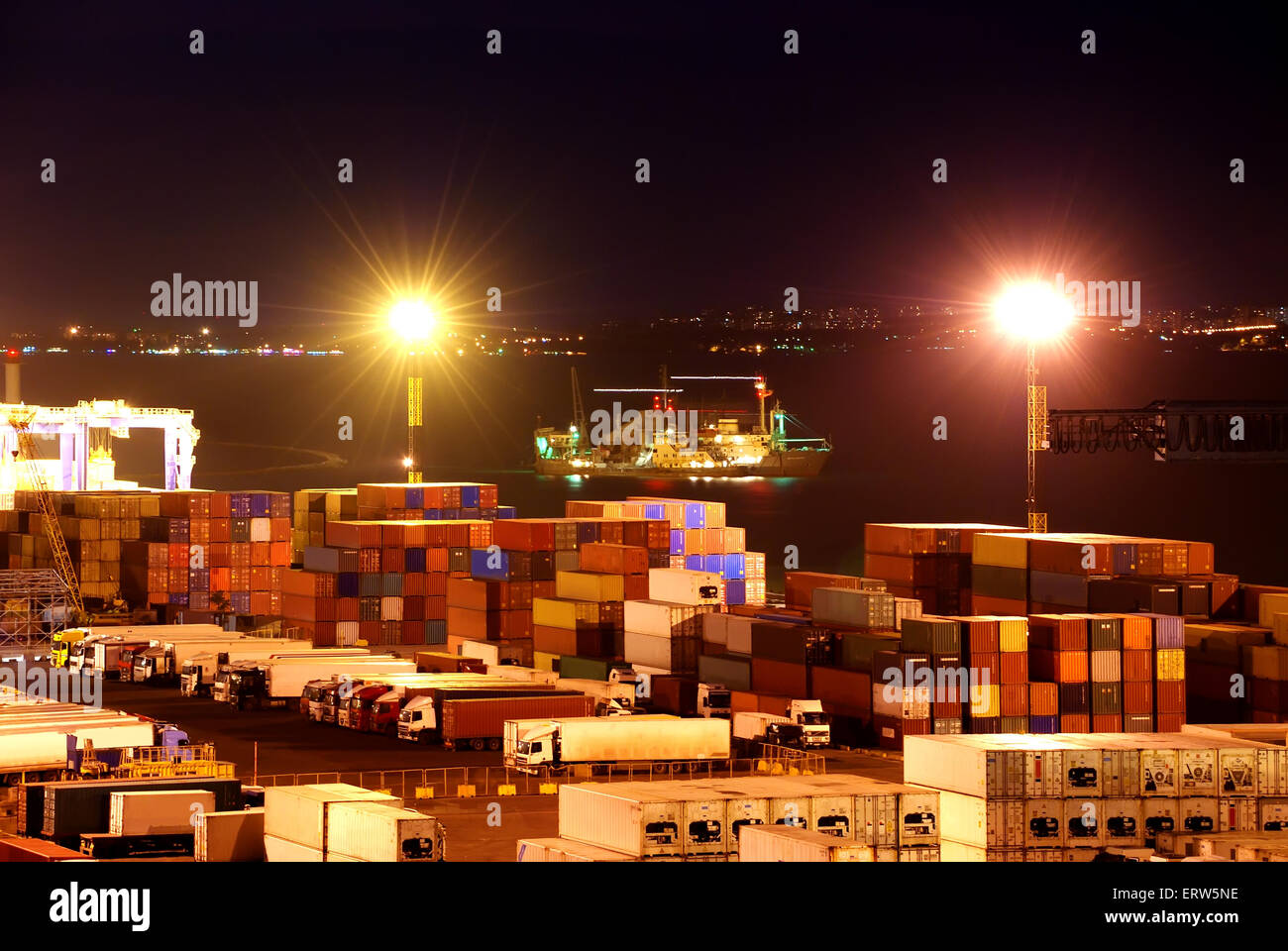 Port warehouse with cargoes and containers at night Stock Photo - Alamy