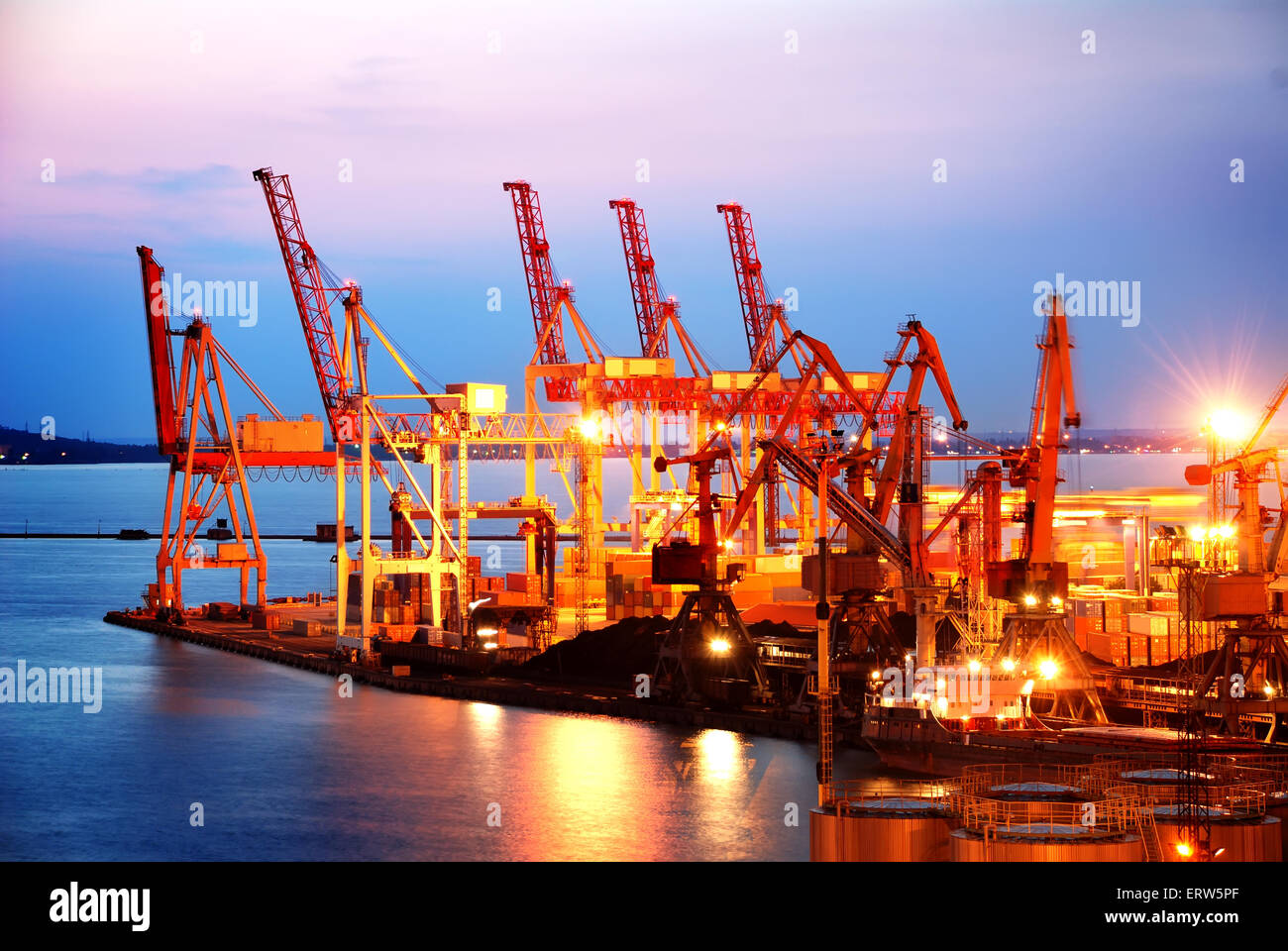 Port warehouse with cargoes and containers at night Stock Photo - Alamy