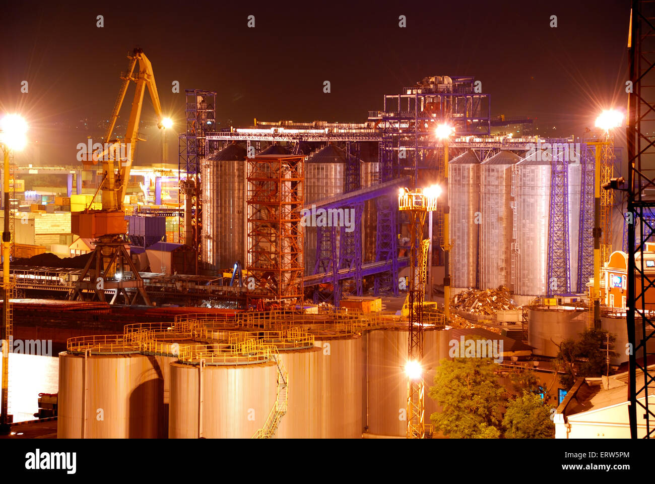 Port warehouse with cargoes and containers at night Stock Photo - Alamy