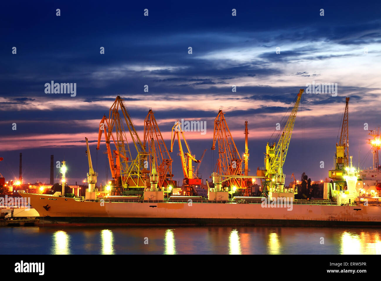 Port warehouse with cargoes and containers at night Stock Photo - Alamy