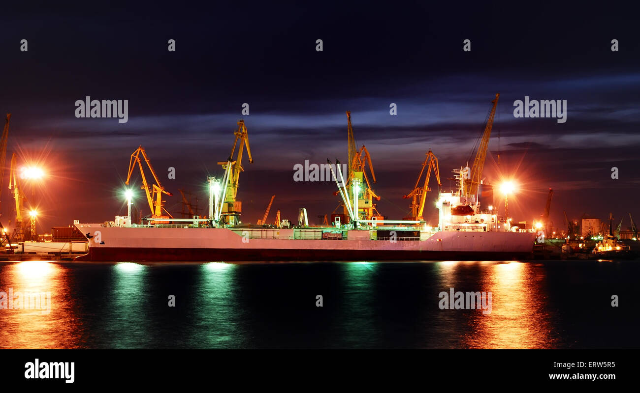 Port warehouse with cargoes and containers at night Stock Photo - Alamy