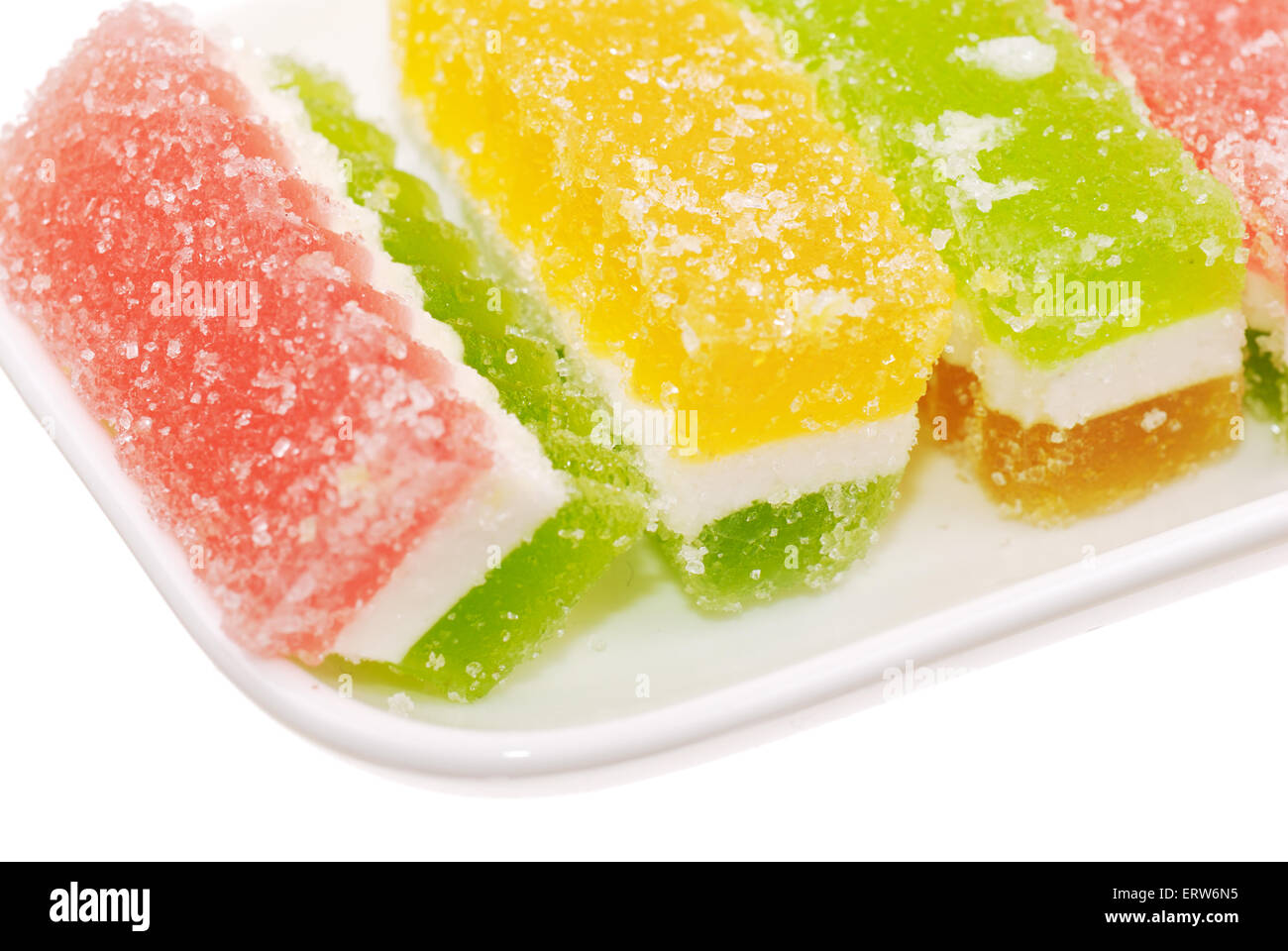 Fruit candy slices on plate isolated Stock Photo - Alamy