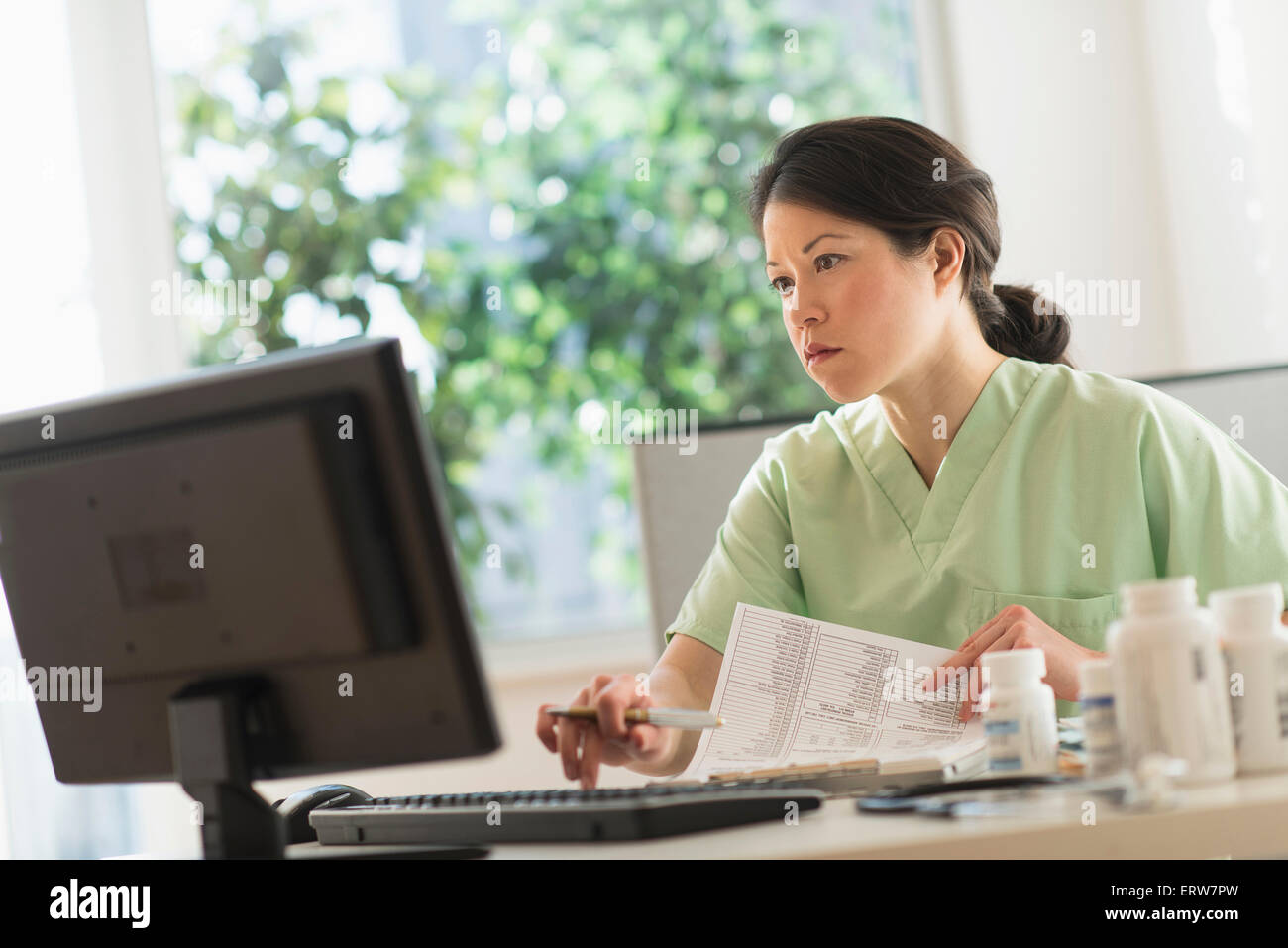 Mixed race nurse working on computer in hospital Stock Photo - Alamy