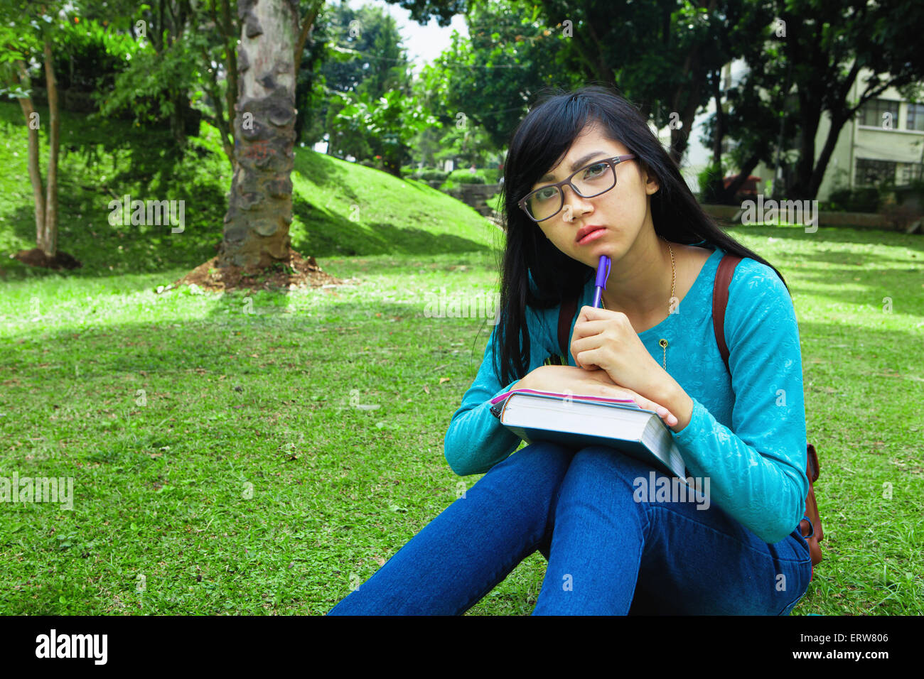 College student hold books, writing, posing and studying outdoor in ...