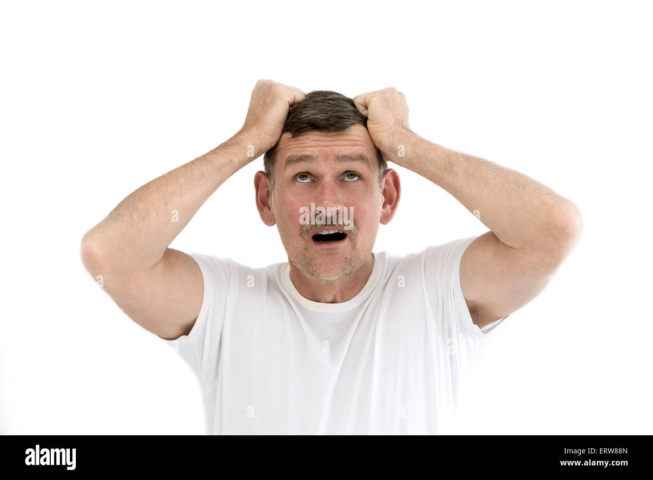 Portrait of a man with his hands to his head Stock Photo - Alamy