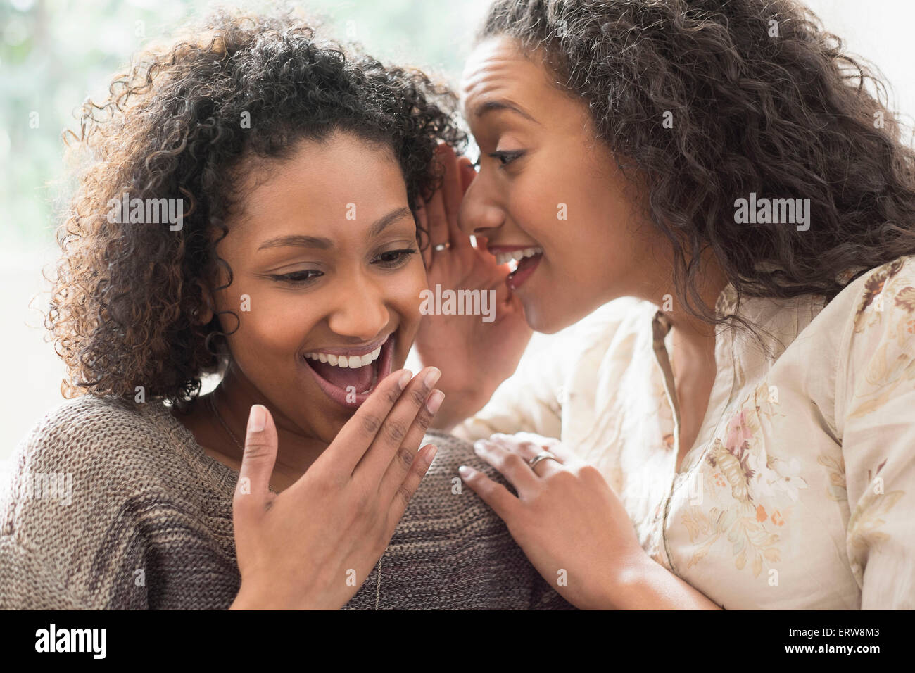 Two laughing young women whispering hi-res stock photography and images - Alamy