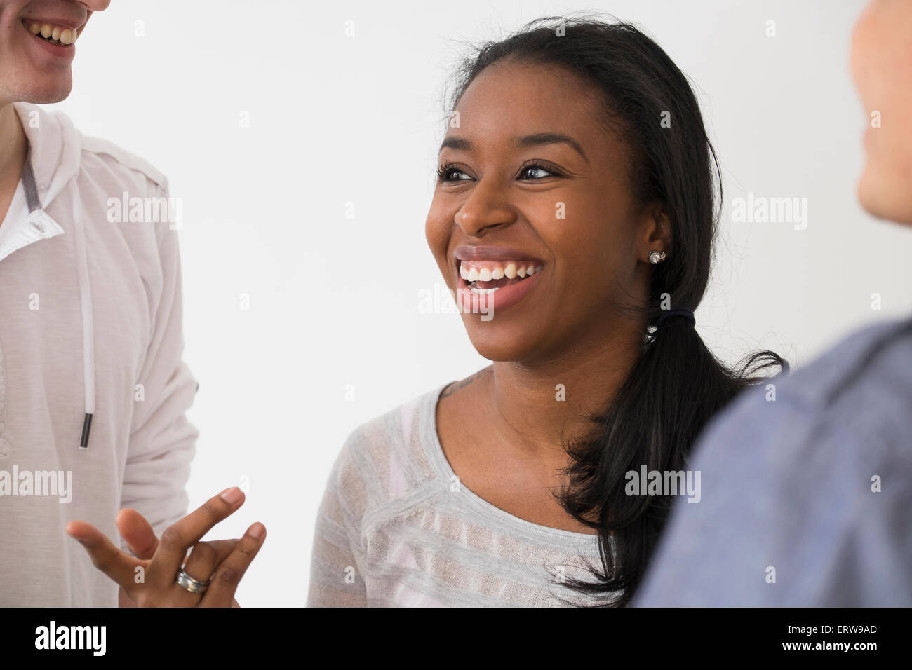Smiling friends talking Stock Photo - Alamy