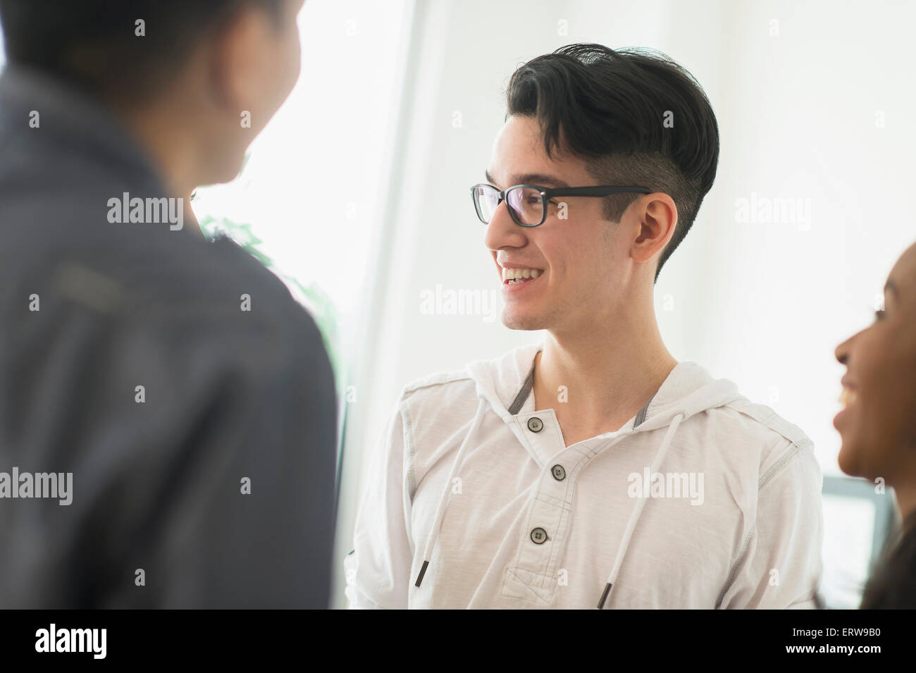 Smiling friends talking Stock Photo - Alamy