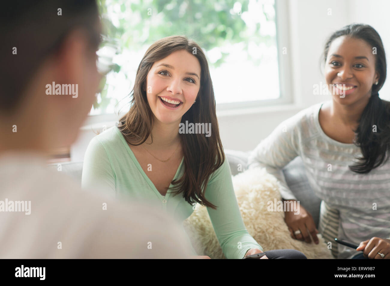 Smiling friends talking Stock Photo - Alamy