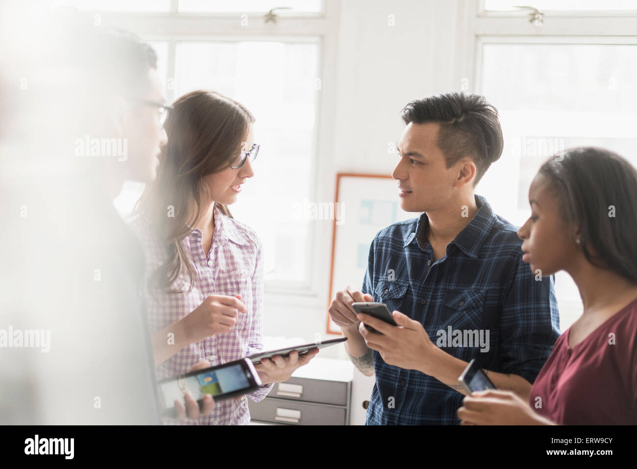 Business people working together in office with technology Stock Photo ...